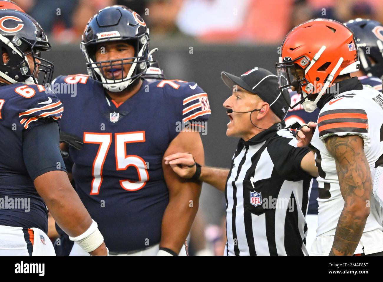 NFL field judge Nate Jones stands between players during an NFL ...