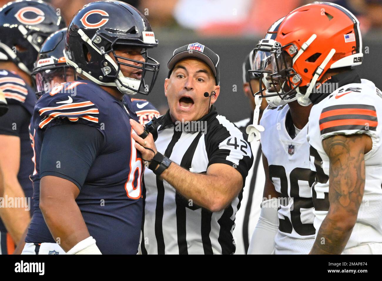 NFL field judge Nate Jones stands between players during an NFL ...