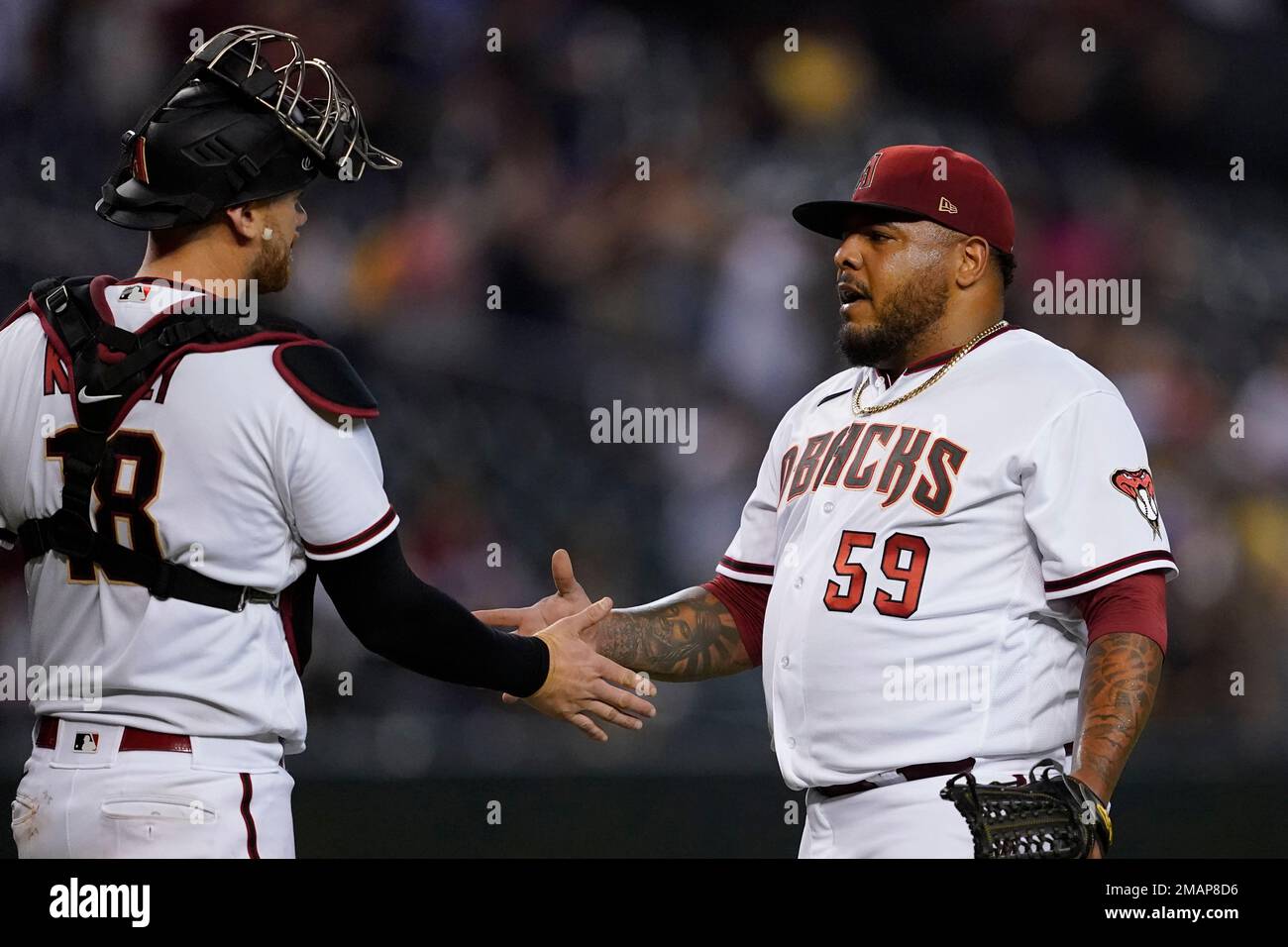 Arizona Diamondbacks catcher Carson Kelly greets relief pitcher Reyes ...