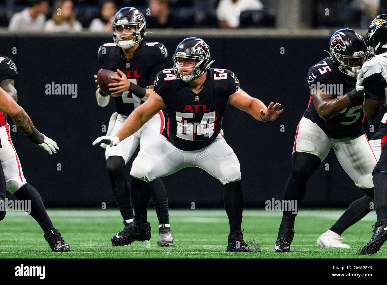 Atlanta Falcons guard Ryan Neuzil (64) works during the first half of ...