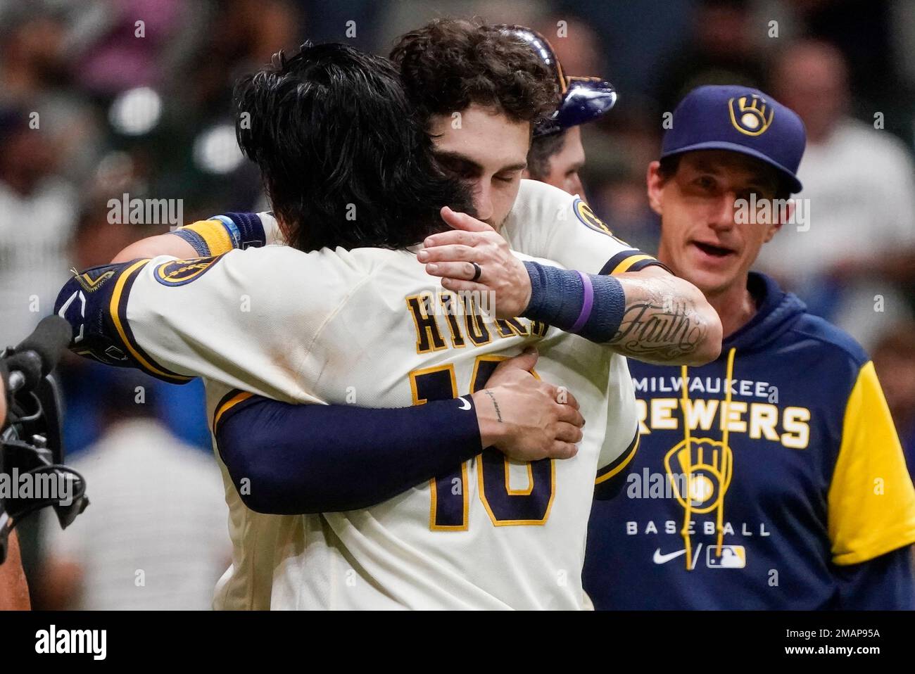 Milwaukee Brewers' Keston Hiura hugs Garrett Mitchell after a baseball ...