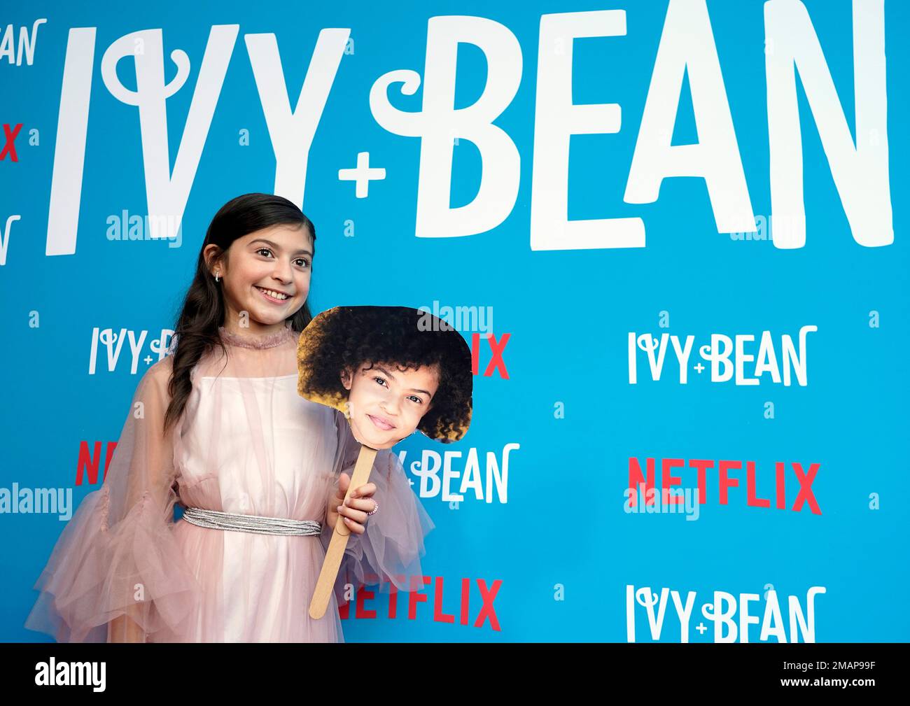 Keslee Blalock, a cast member in "Ivy + Bean," holds up a cutout of her ...
