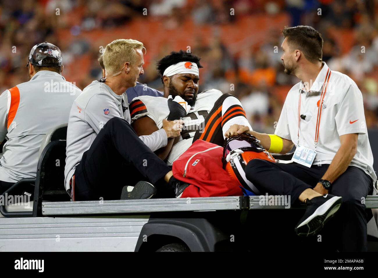 Cleveland Browns defensive end Chris Odom (61) is carted off of the ...
