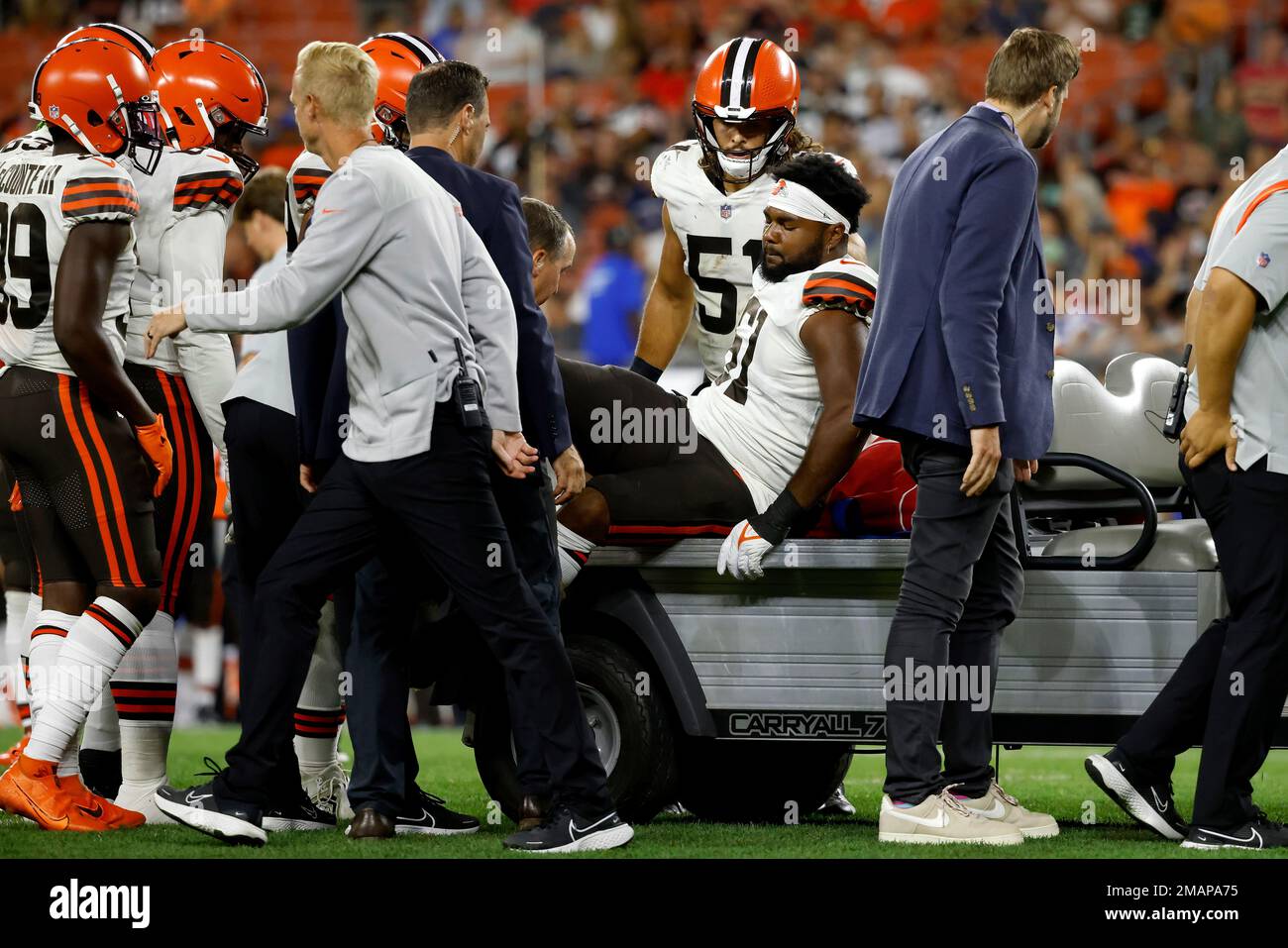 Cleveland Browns defensive end Chris Odom (61) is carted off of the ...