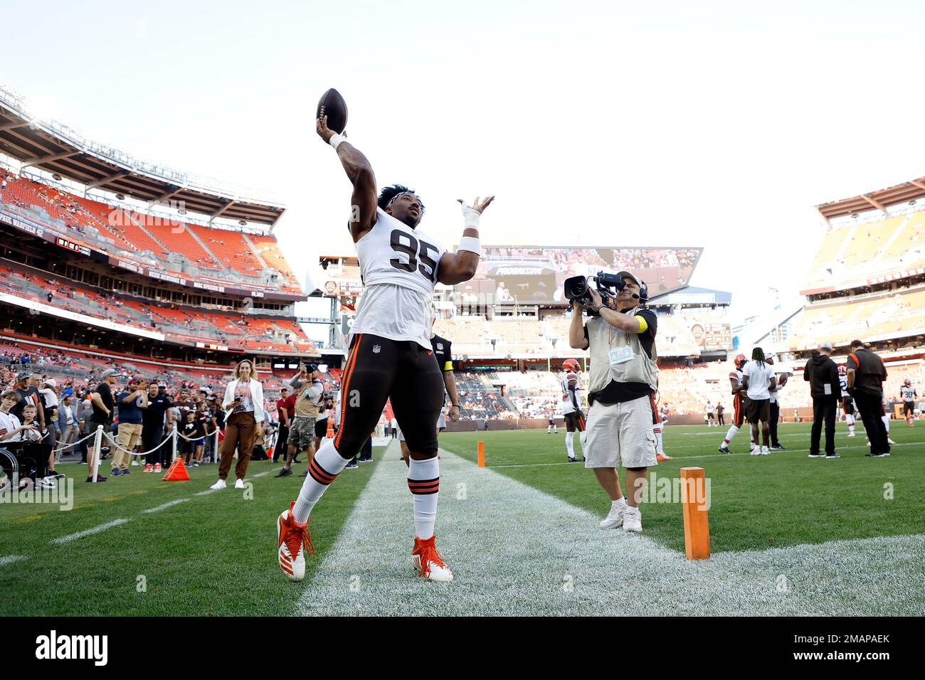 Cleveland Browns defensive end Myles Garrett (95) throws a football ...