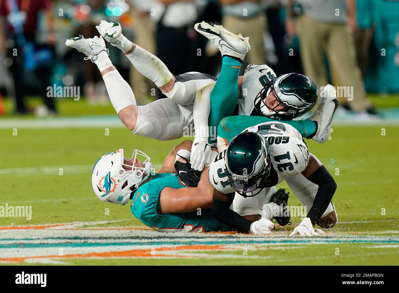 Miami Dolphins wide receiver Erik Ezukanma, left, is tackled by ...
