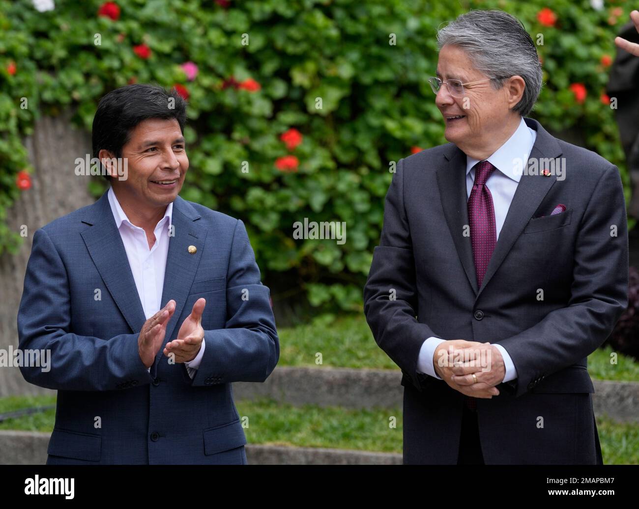 Peru's President Pedro Castillo, left, stands next to Ecuador's ...