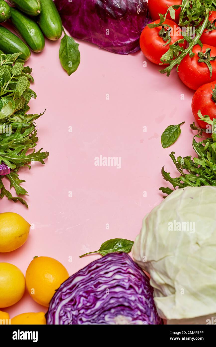 fresh vegetables on a pink background with copyspaced in the top right ...