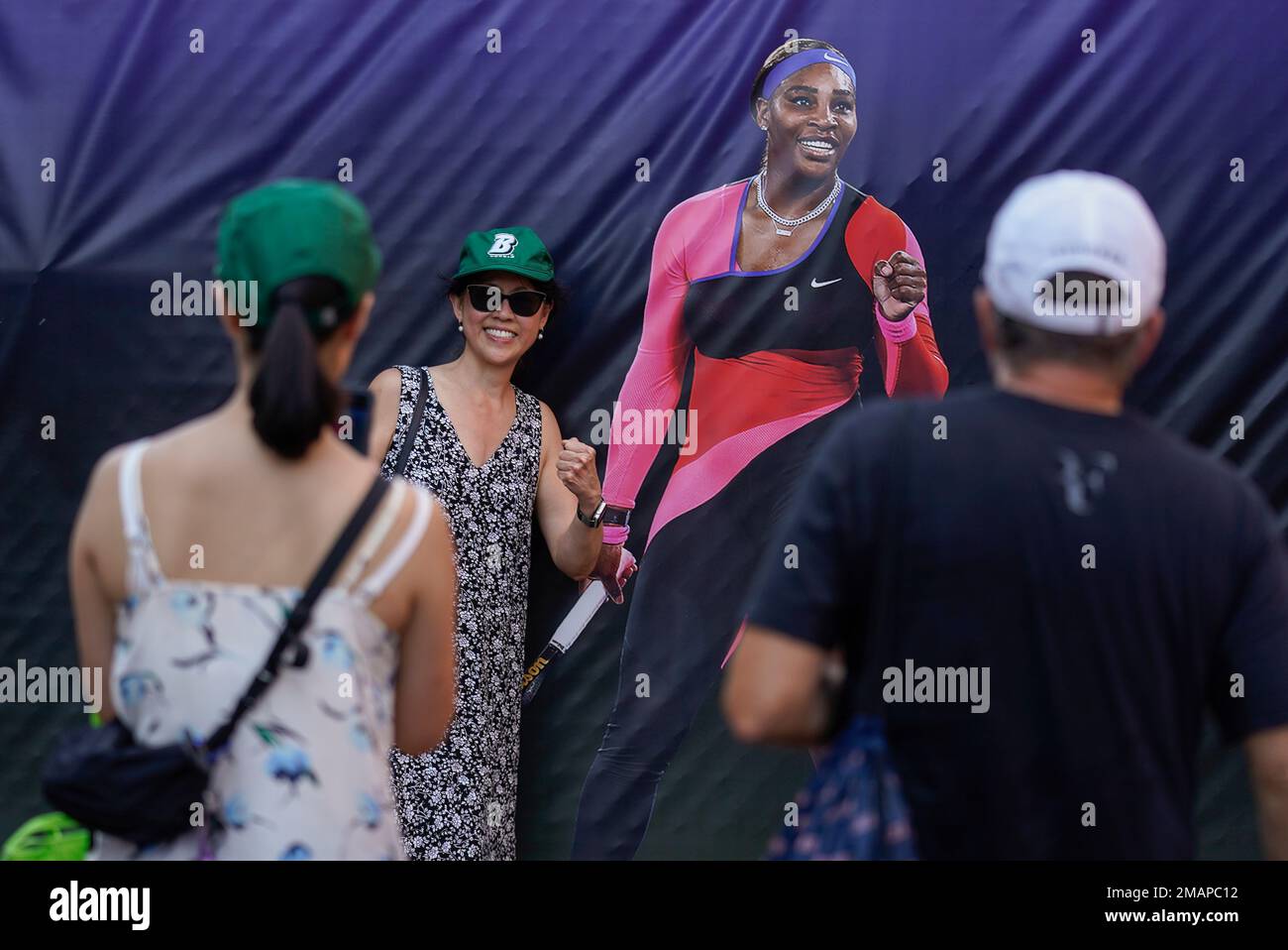 Tennis fans pose for photos next to a life-sized image of Serena ...