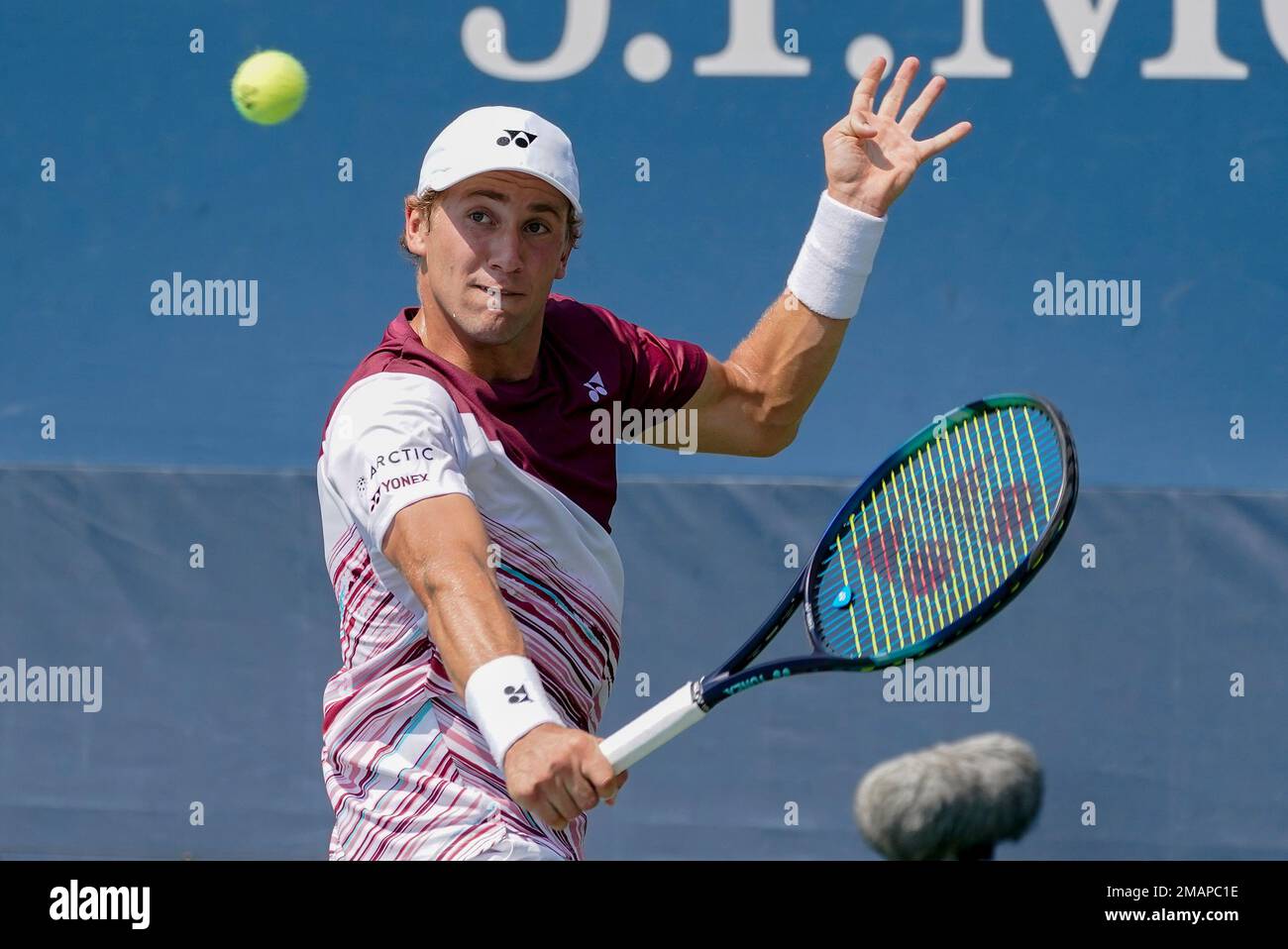 Casper Ruud, of Norway, returns a shot to Kyle Edmund, of Great Britain, during the first round ...