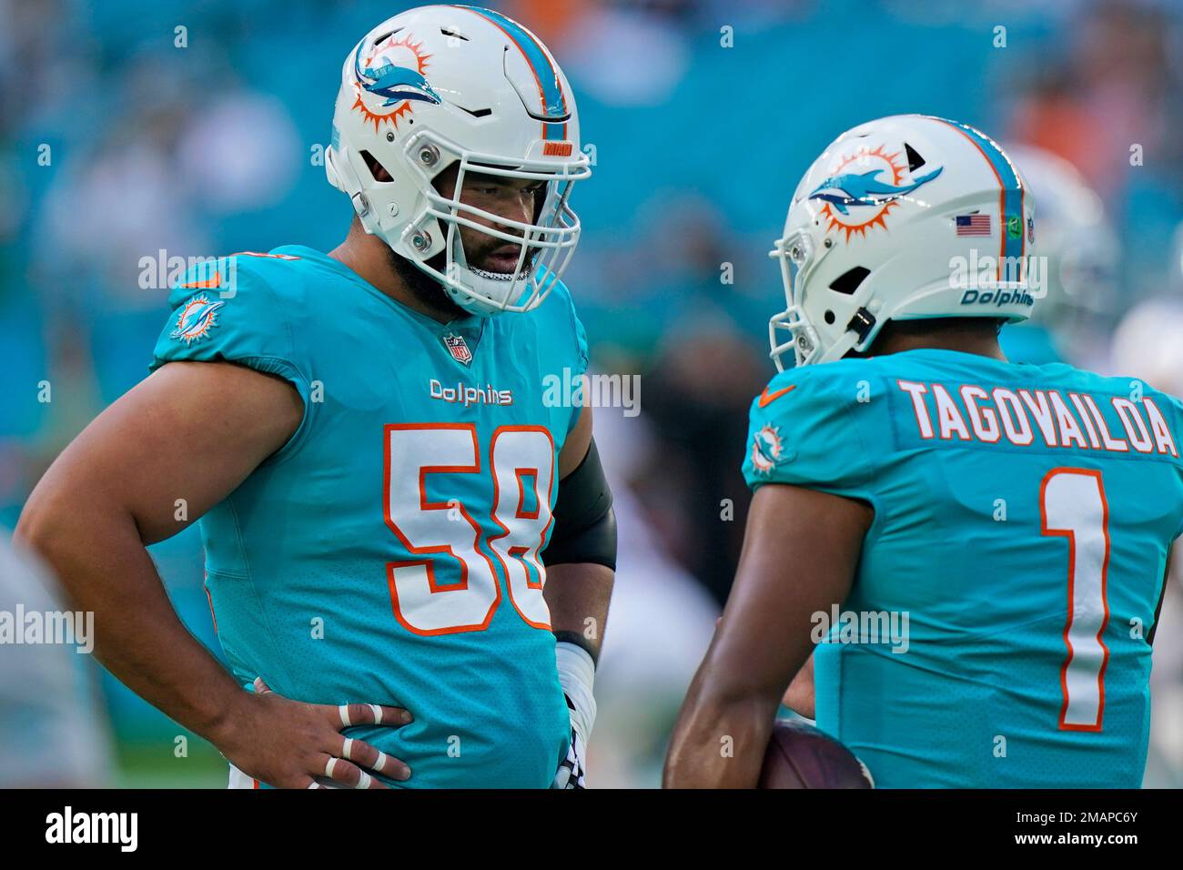 Miami Dolphins quarterback Tua Tagovailoa (1) talks with guard Connor ...