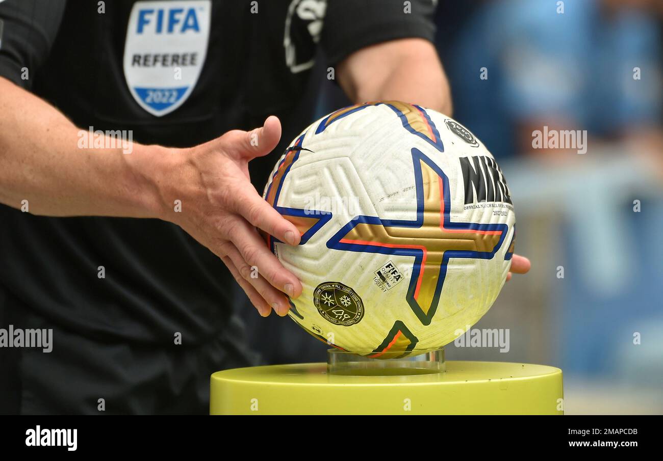 A close up view of referee's hands collecting match ball before the ...
