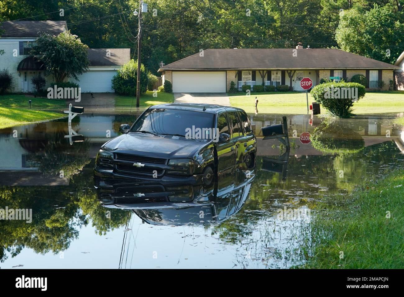 An SUV rests in flood waters in this northeast Jackson, Miss ...