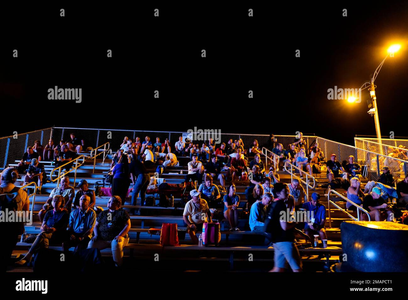 Spectators wait for the NASA moon rocket on Pad 39B before the Artemis ...