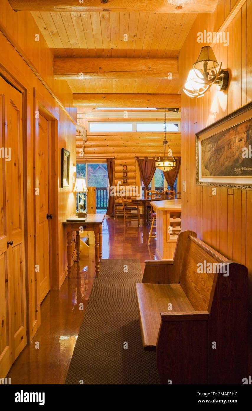 Wooden long bench in main entry hall inside Scandinavian style log home ...
