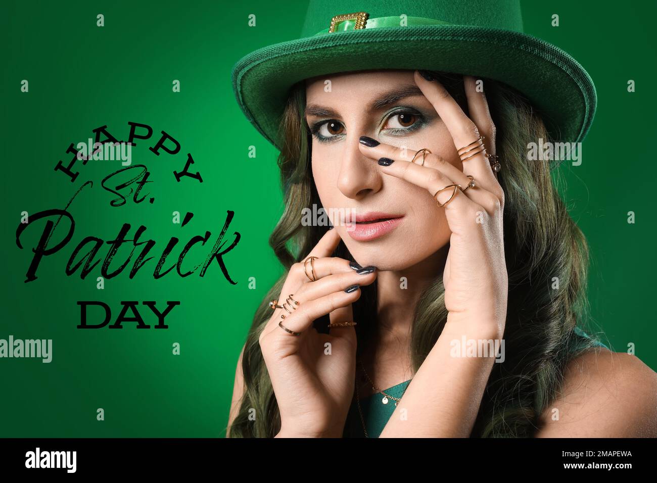 Stylish young woman dressed for St. Patrick's Day party on green ...