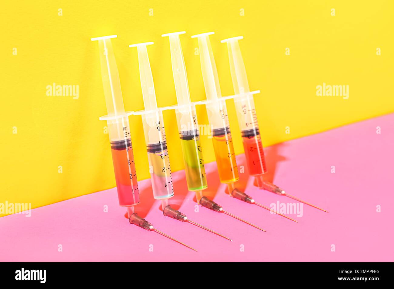 Medical syringes with remedy on color background Stock Photo - Alamy