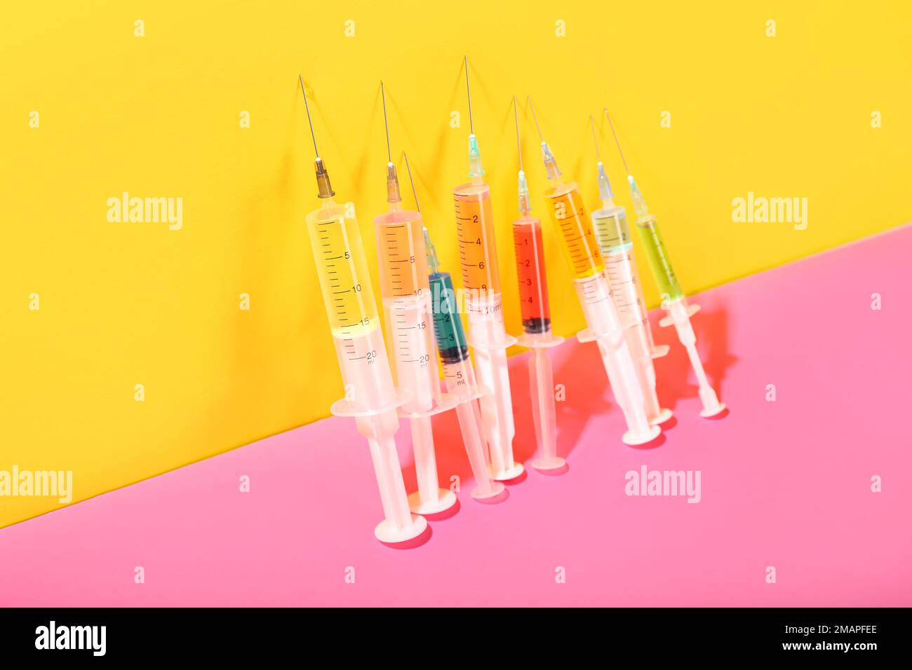 Medical syringes with remedy on color background Stock Photo - Alamy