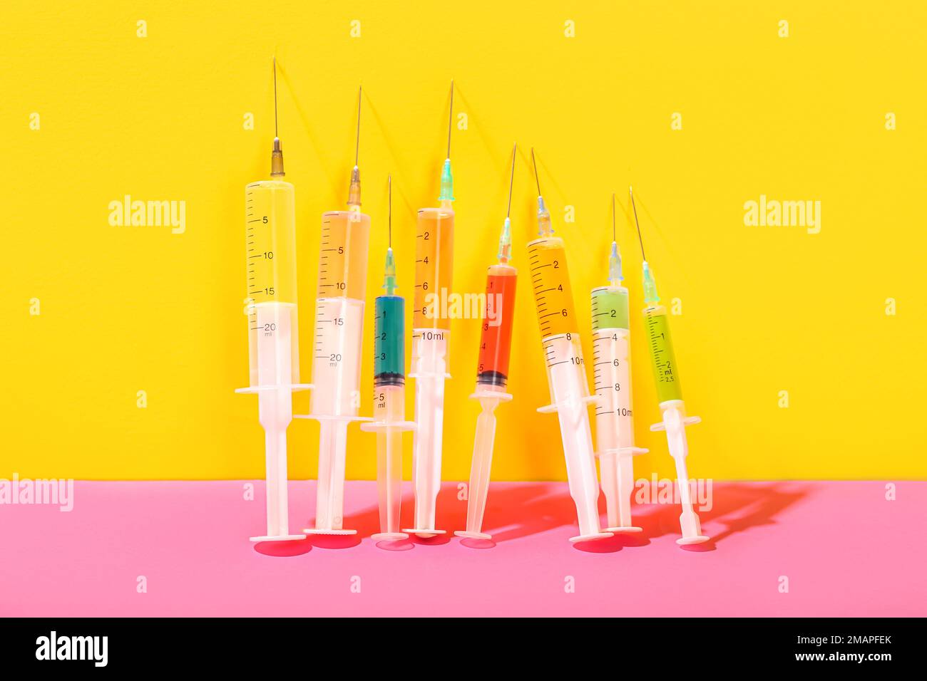 Medical syringes with remedy on color background Stock Photo - Alamy