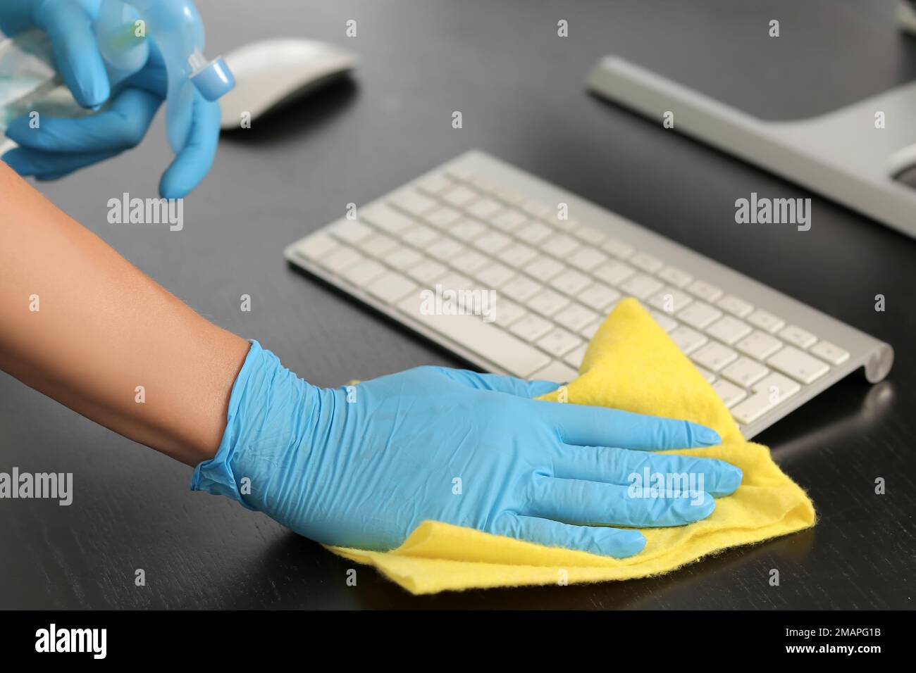 Female janitor cleaning table in office, closeup Stock Photo - Alamy