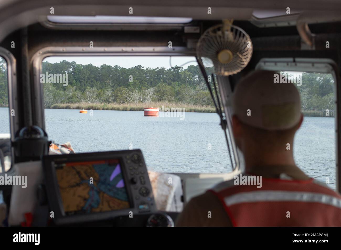 U.S. Navy Petty Officer 3rd Class Briand Wright, a boat operator ...
