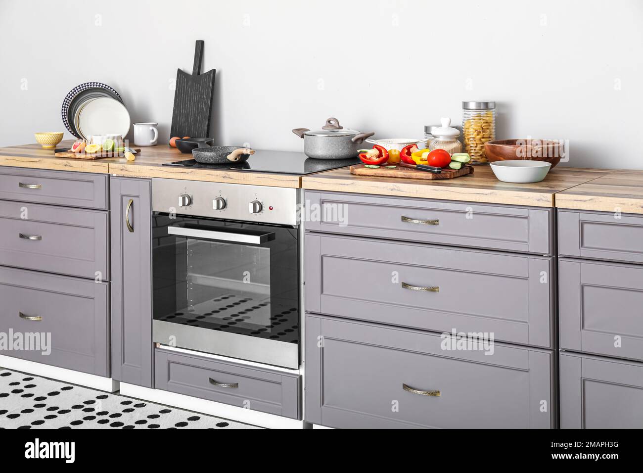 Interior of modern kitchen with grey counter, oven and food Stock Photo ...