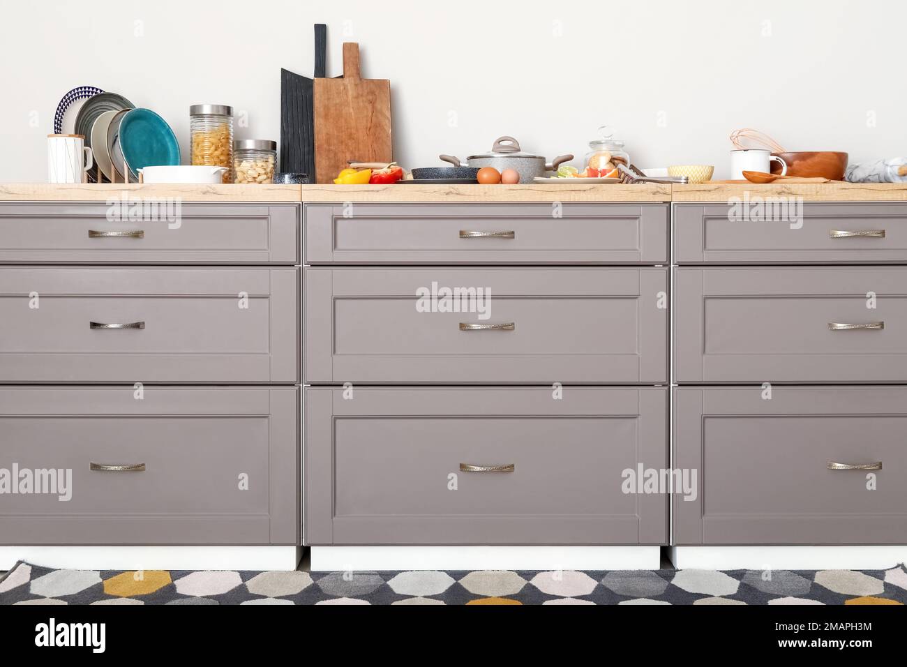 Interior of modern kitchen with grey counters and food Stock Photo - Alamy