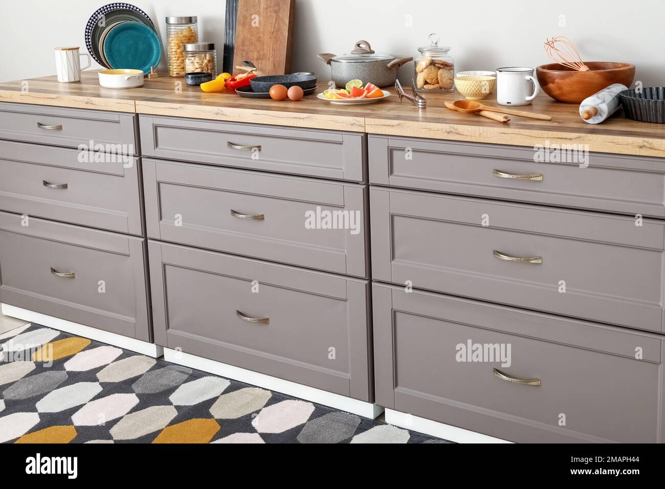 Interior of modern kitchen with grey counters and food Stock Photo - Alamy