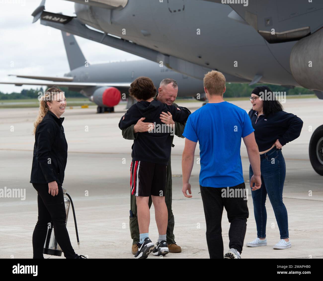 The commander of the 157th Air Refueling Wing, Col. John Pogorek, hugs ...