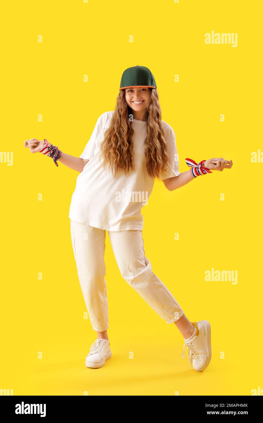 Female hip-hop dancer on yellow background Stock Photo - Alamy