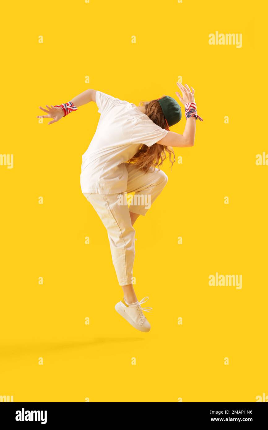 Female hip-hop dancer on yellow background Stock Photo - Alamy