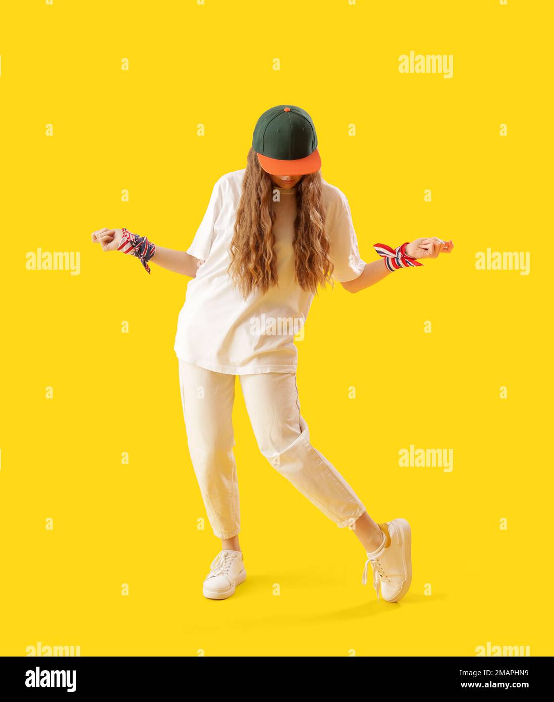 Female hip-hop dancer on yellow background Stock Photo - Alamy