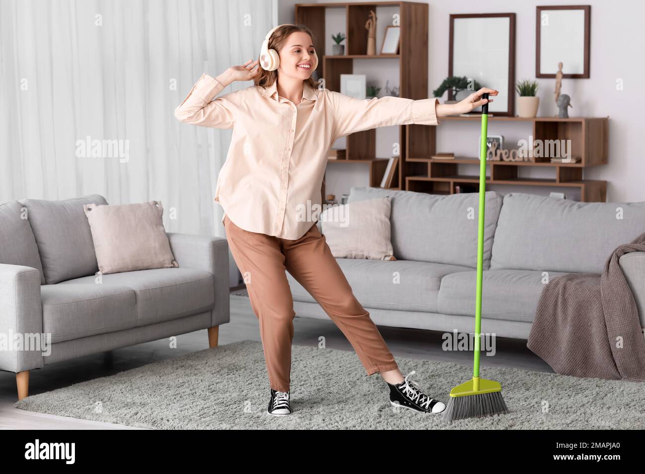Woman dancing while sweeping hi-res stock photography and images - Alamy