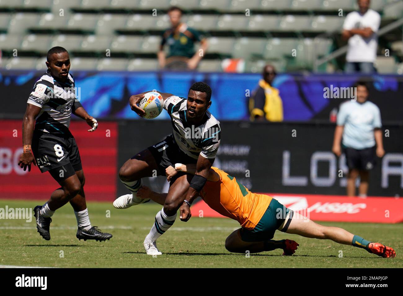 Australia'sJosh Turner, right grabs and tackles Fiji's Kaminieli Rasaku ...
