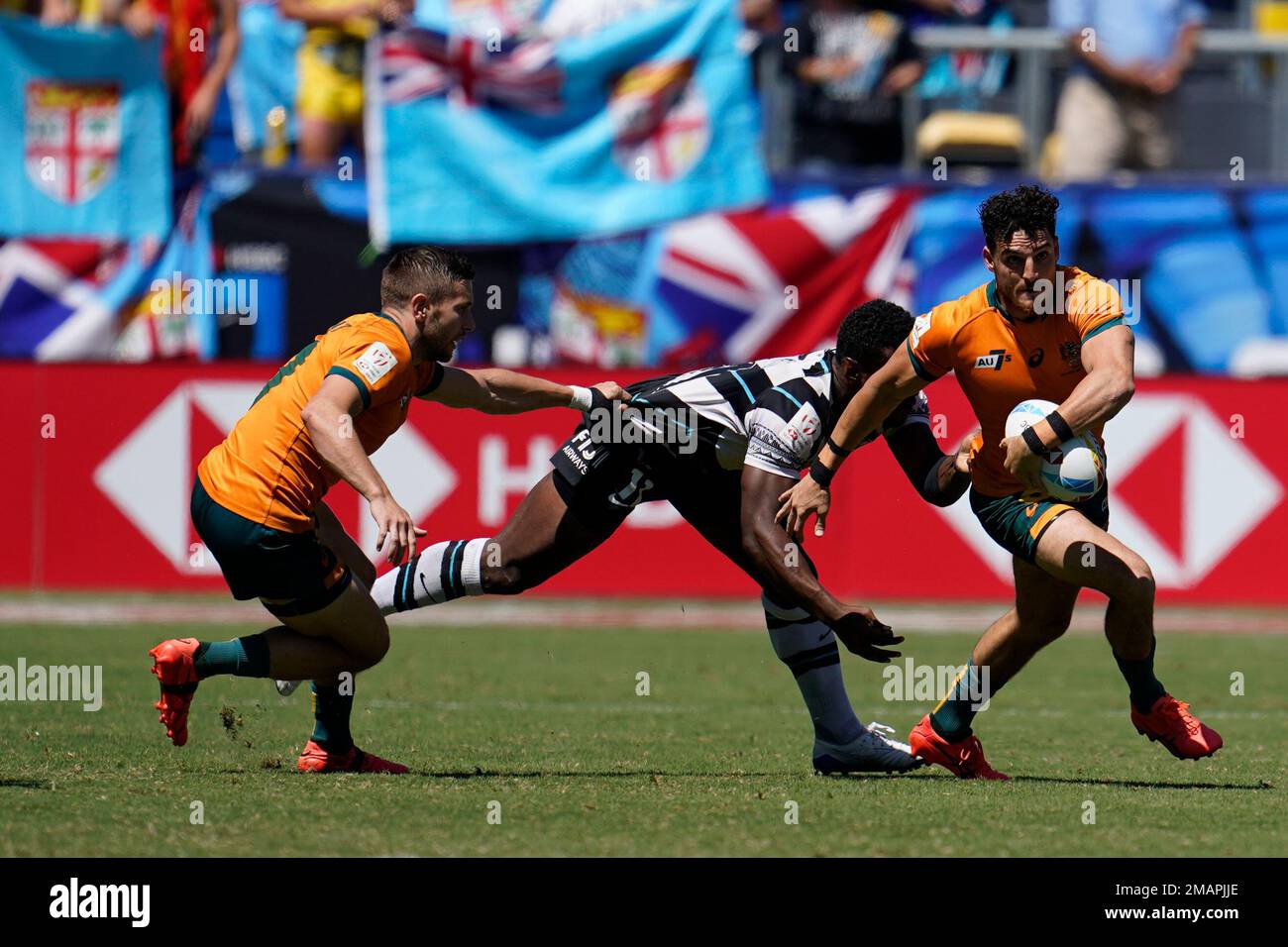 Australia's Matthew Gonzalez, right is tackled by Fiji's Kaminieli ...