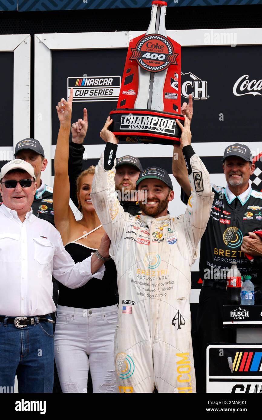 Austin Dillon lifts the championship trophy with his wife Whitney ...