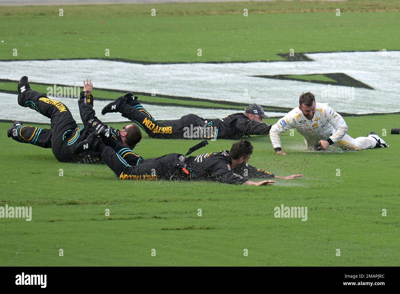 Austin Dillon, right, celebrates by sliding on the infield grass with ...