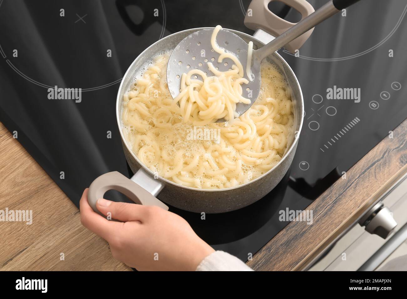 Pasta cooking hand pot female hi-res stock photography and images - Alamy