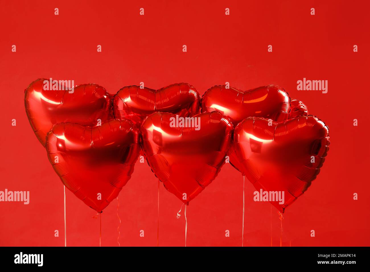 Heart shaped balloons for Valentine's Day on red background Stock Photo ...
