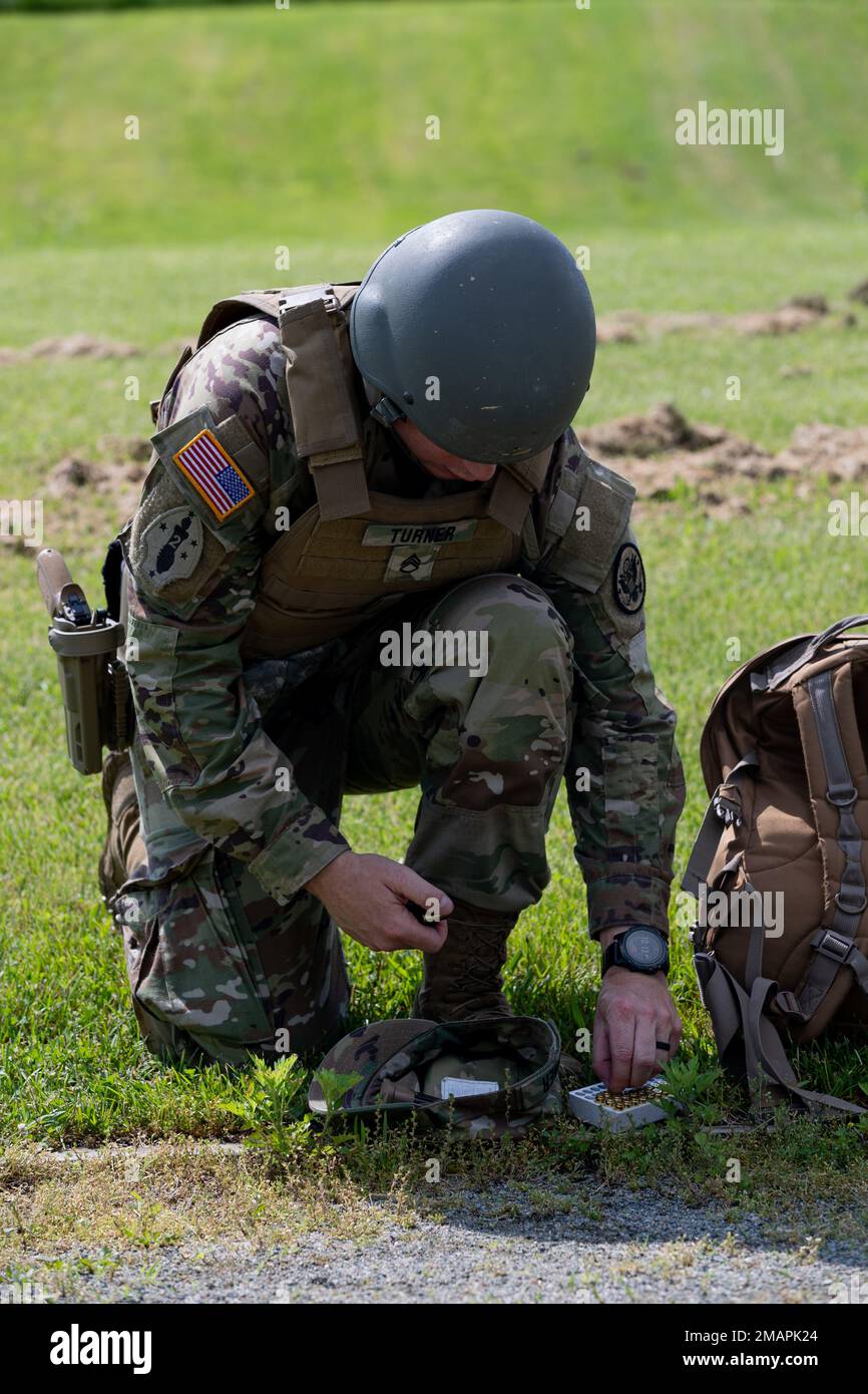 Staff Sgt. Ian Turner, with the 2nd CST, reloads his M9 pistol at the ...