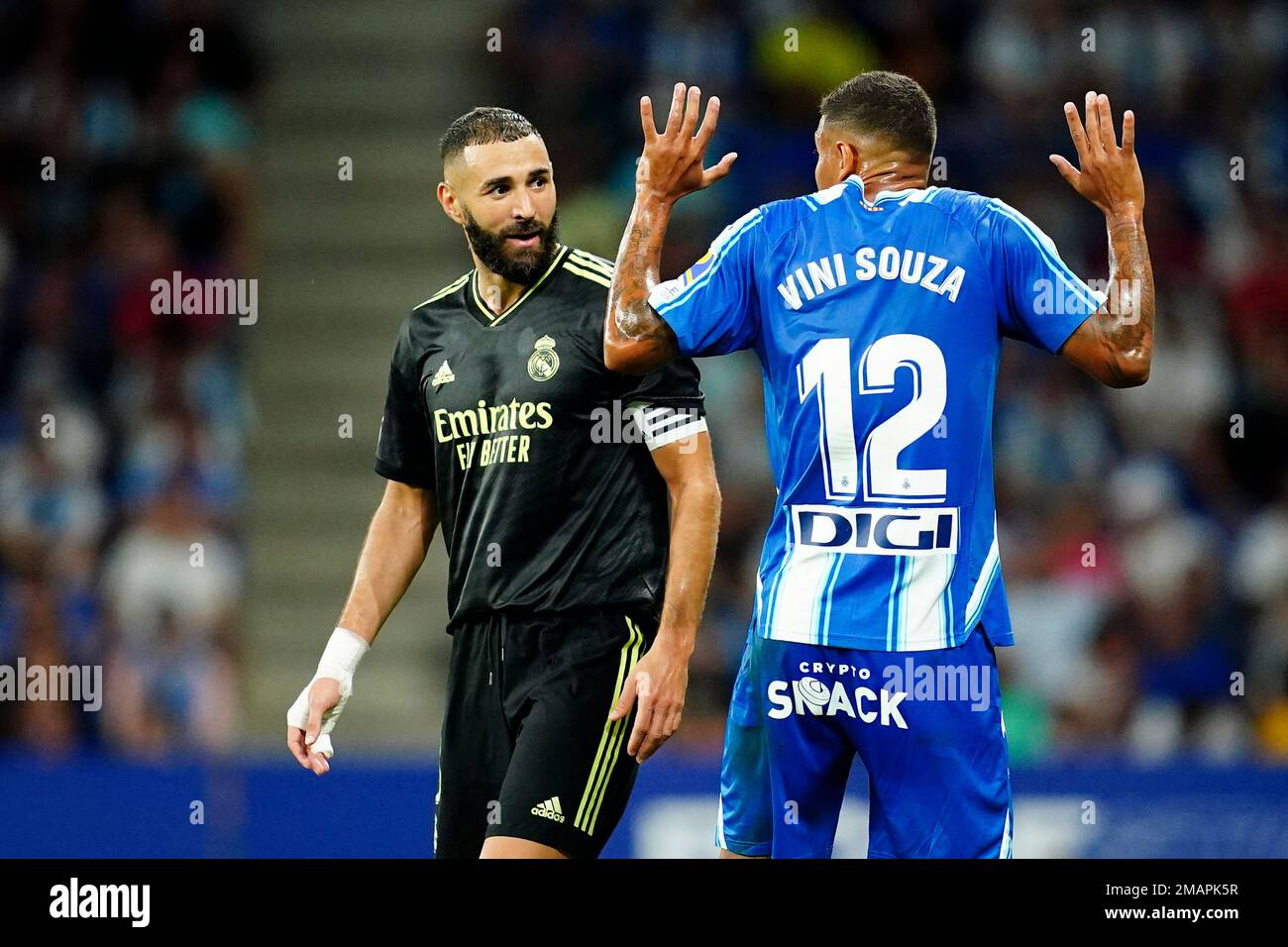 Real Madrid's Karim Benzema looks at Espanyol's Vinicius Souza after a ...