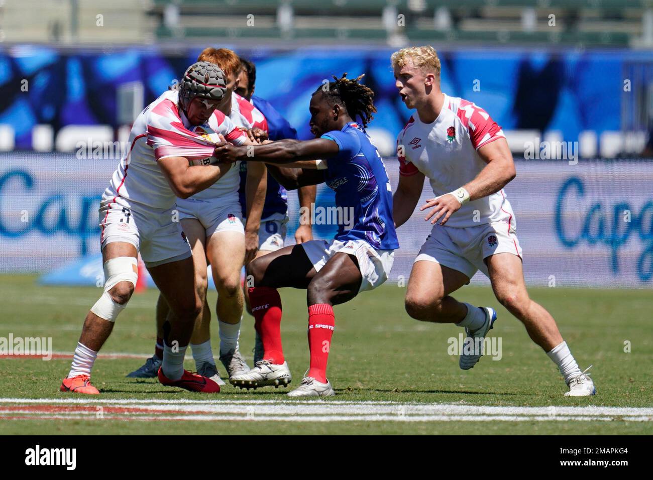 England's Ethan Waddleton, left is grappled by William Iraguha of ...