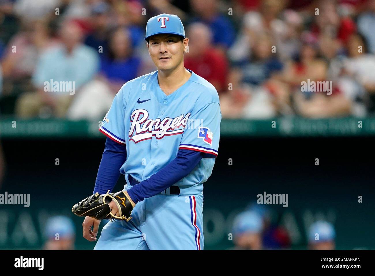 Texas Rangers starting pitcher Kohei Arihara smiles after walking ...