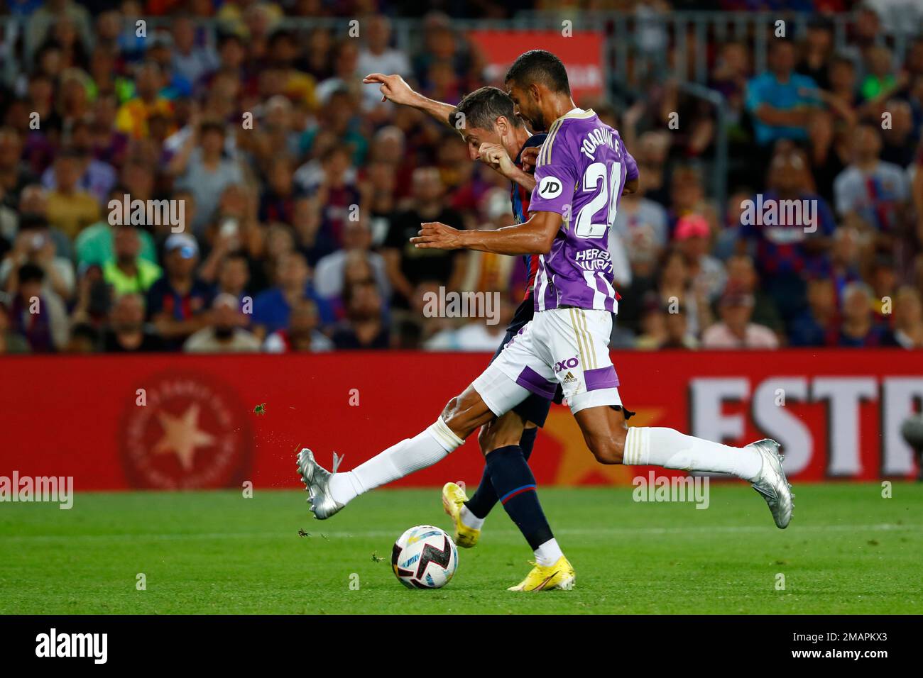 Barcelona's Robert Lewandowski, background, scores his side's third ...