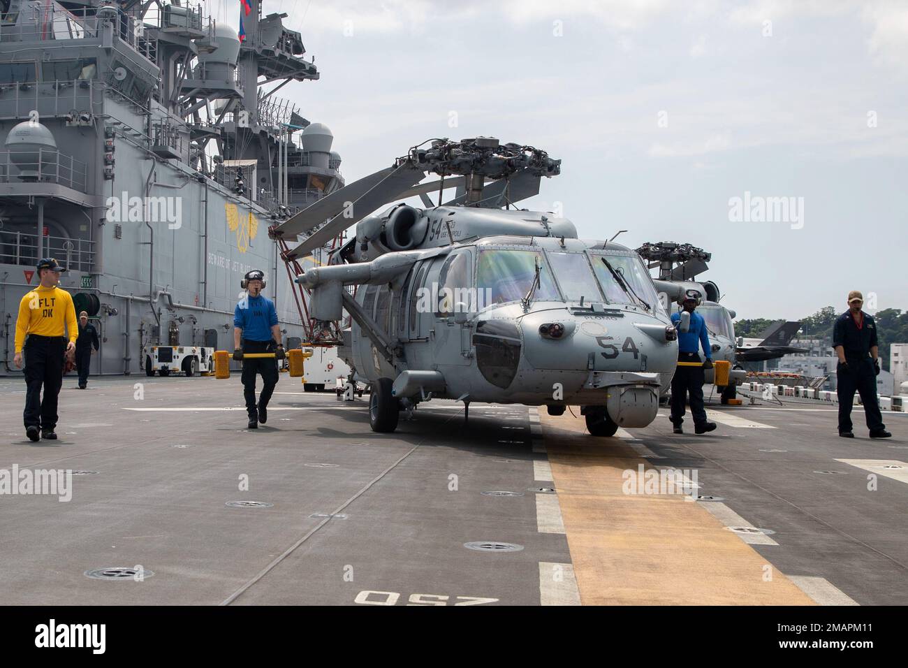 220603-N-IL330-1027 PACIFIC OCEAN (June 03, 2022) – Sailors move an MH ...