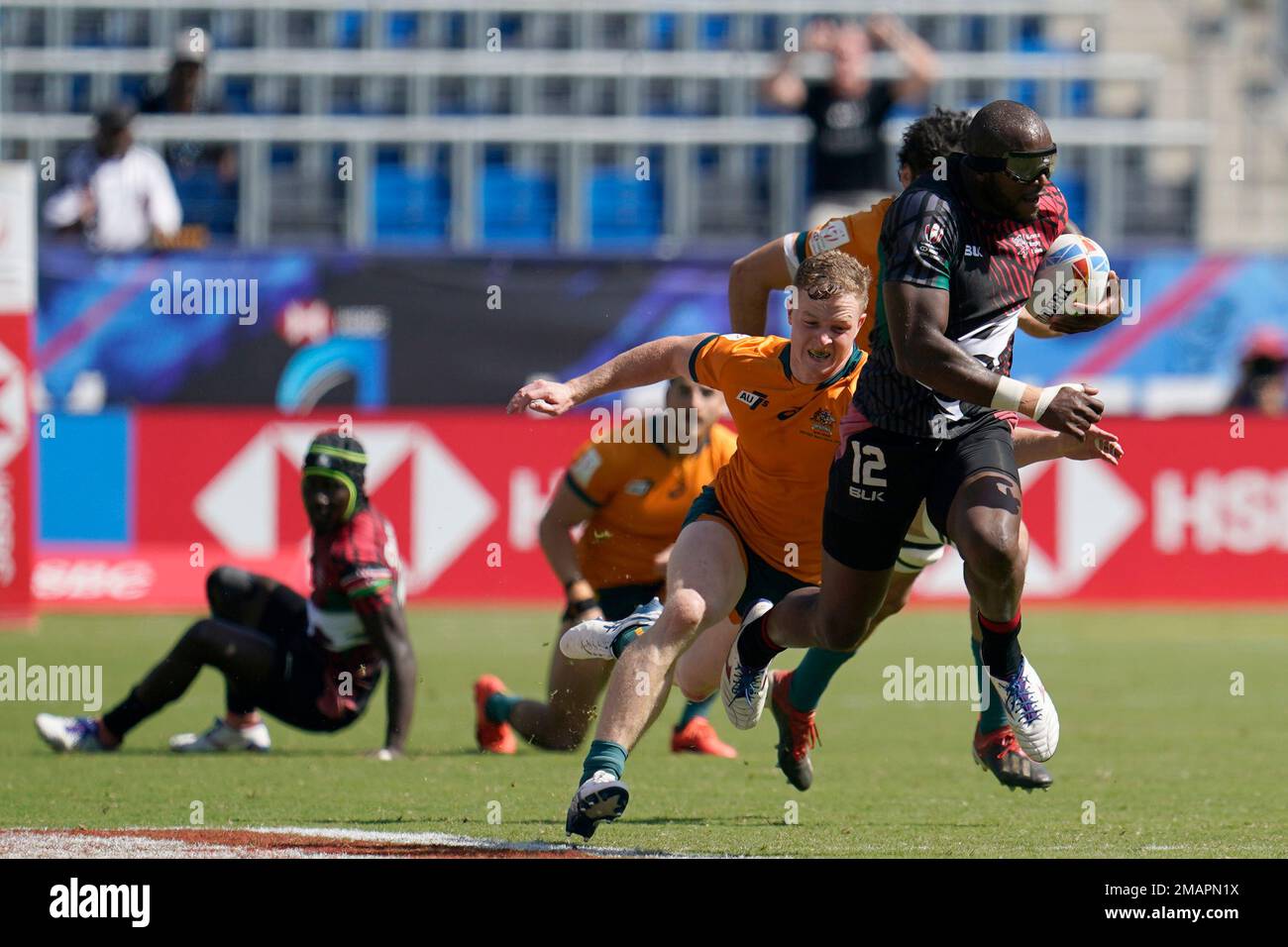 Kenya'sWilly Ambaka gets past the tackle of Australia's Henry Hutchison ...