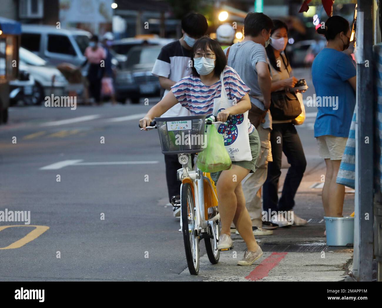 People wear face masks to protect against the spread of the coronavirus ...