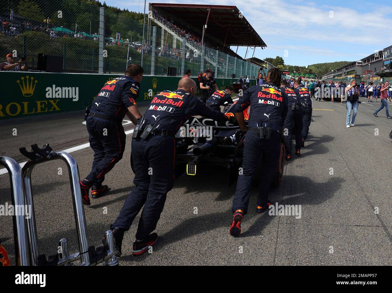 Red Bull crew push their car into the grid position during the Formula ...