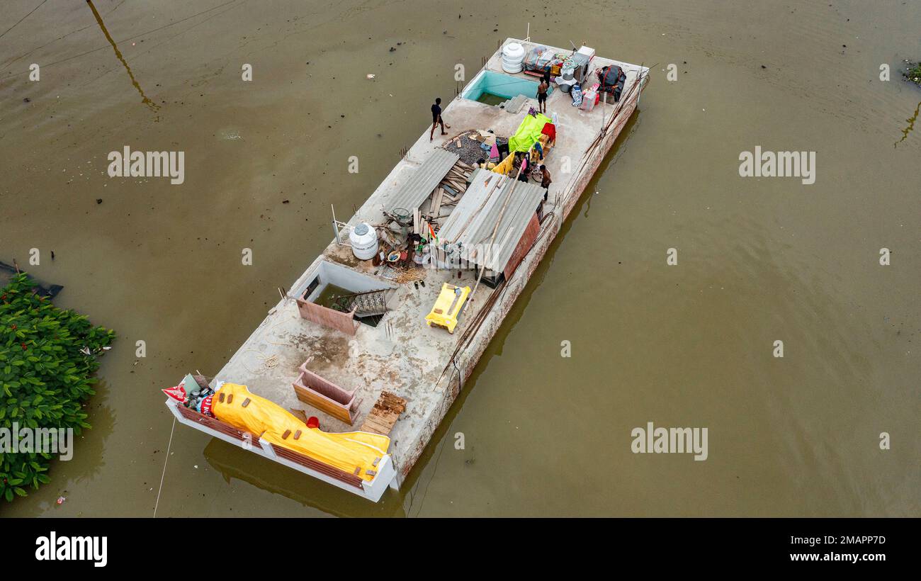 Flood water surrounds a house on the banks of the river Ganges ...