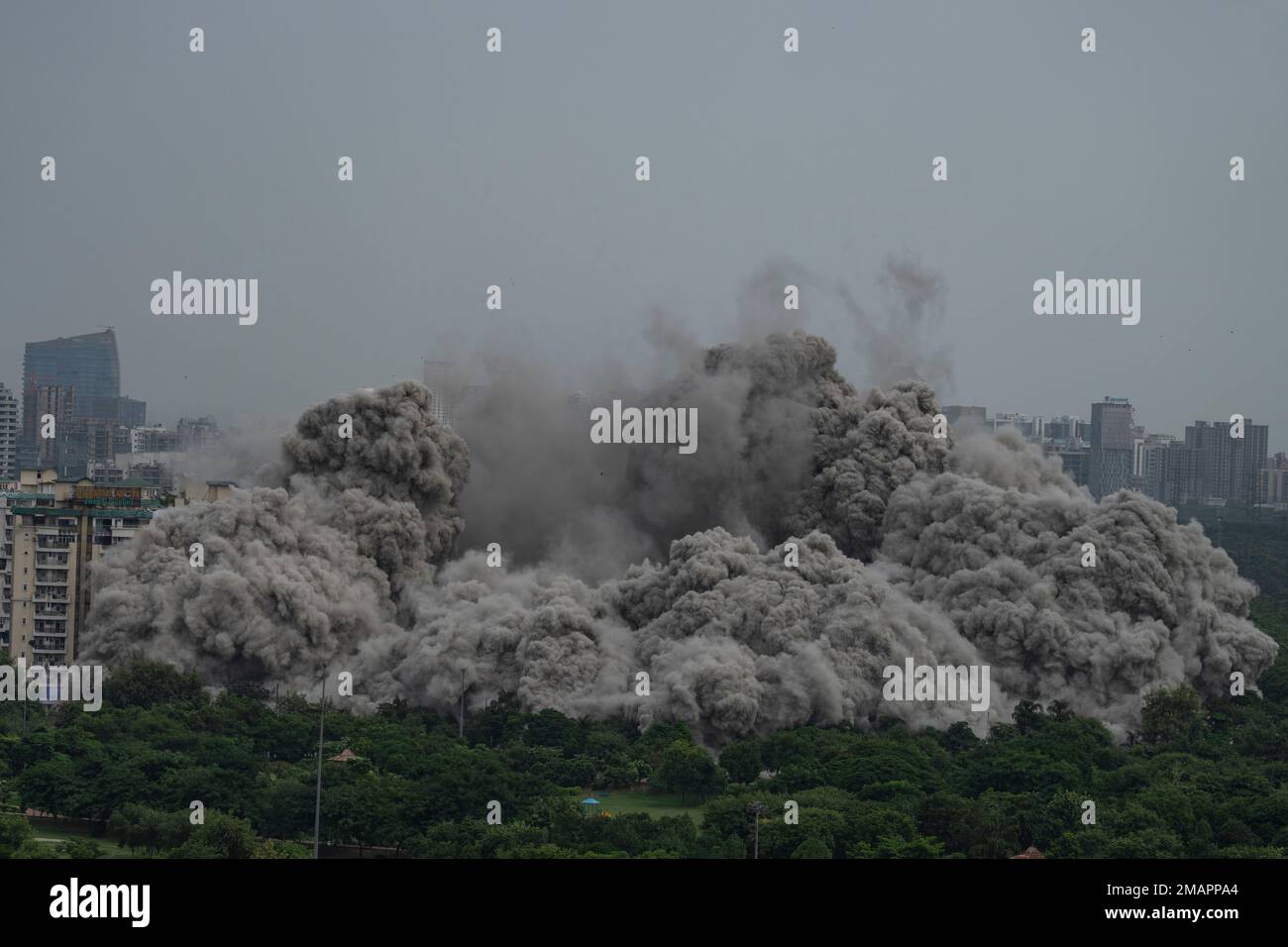 Cloud of dust rises as twin high-rise apartment towers are razed to ...